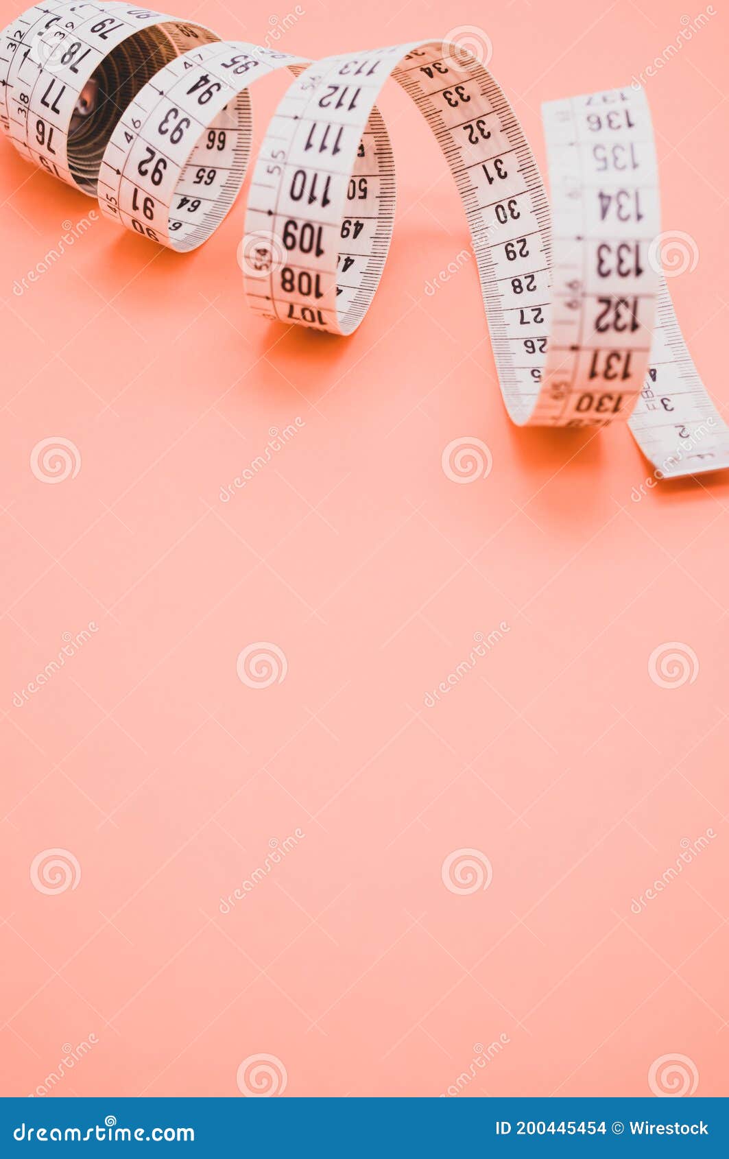 Vertical Shot of a Measuring Tape Isolated on Coral Background Stock ...