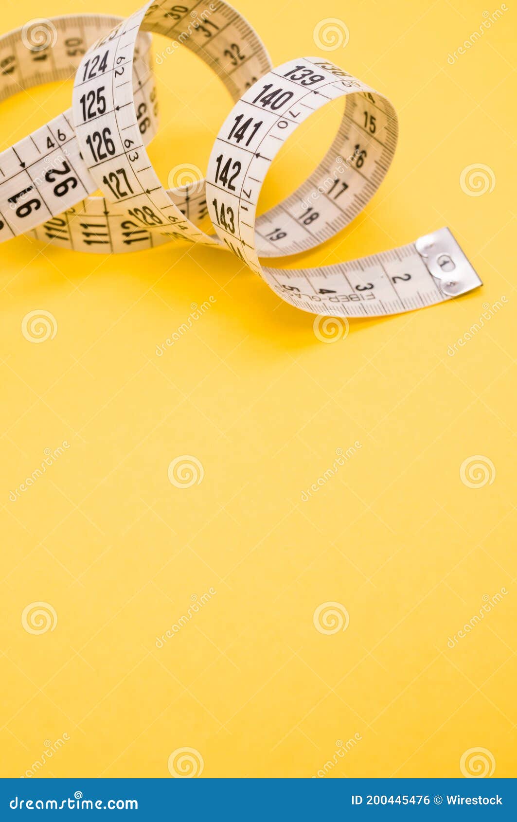 Vertical Shot of a Measuring Tape Isolated on Yellow Background Stock ...