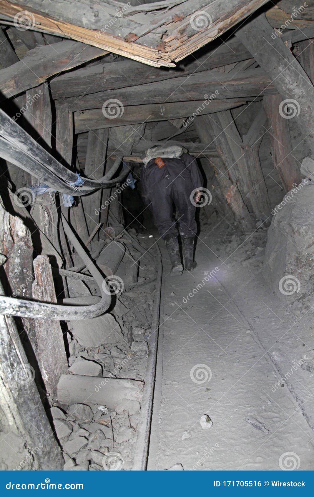 Vertical Shot of Miners Walking in the Cave Stock Photo - Image of ...