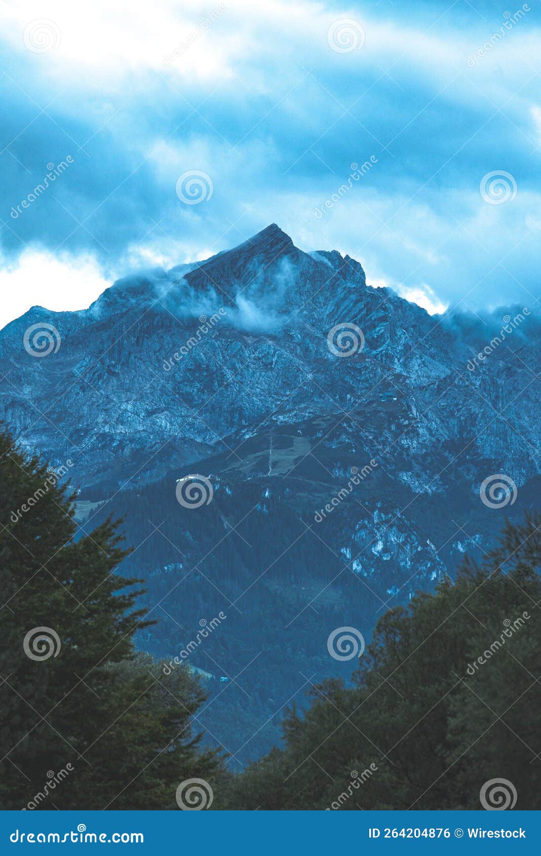 Vertical Shot of a Mountain Peak in the Clouds Stock Photo - Image of ...