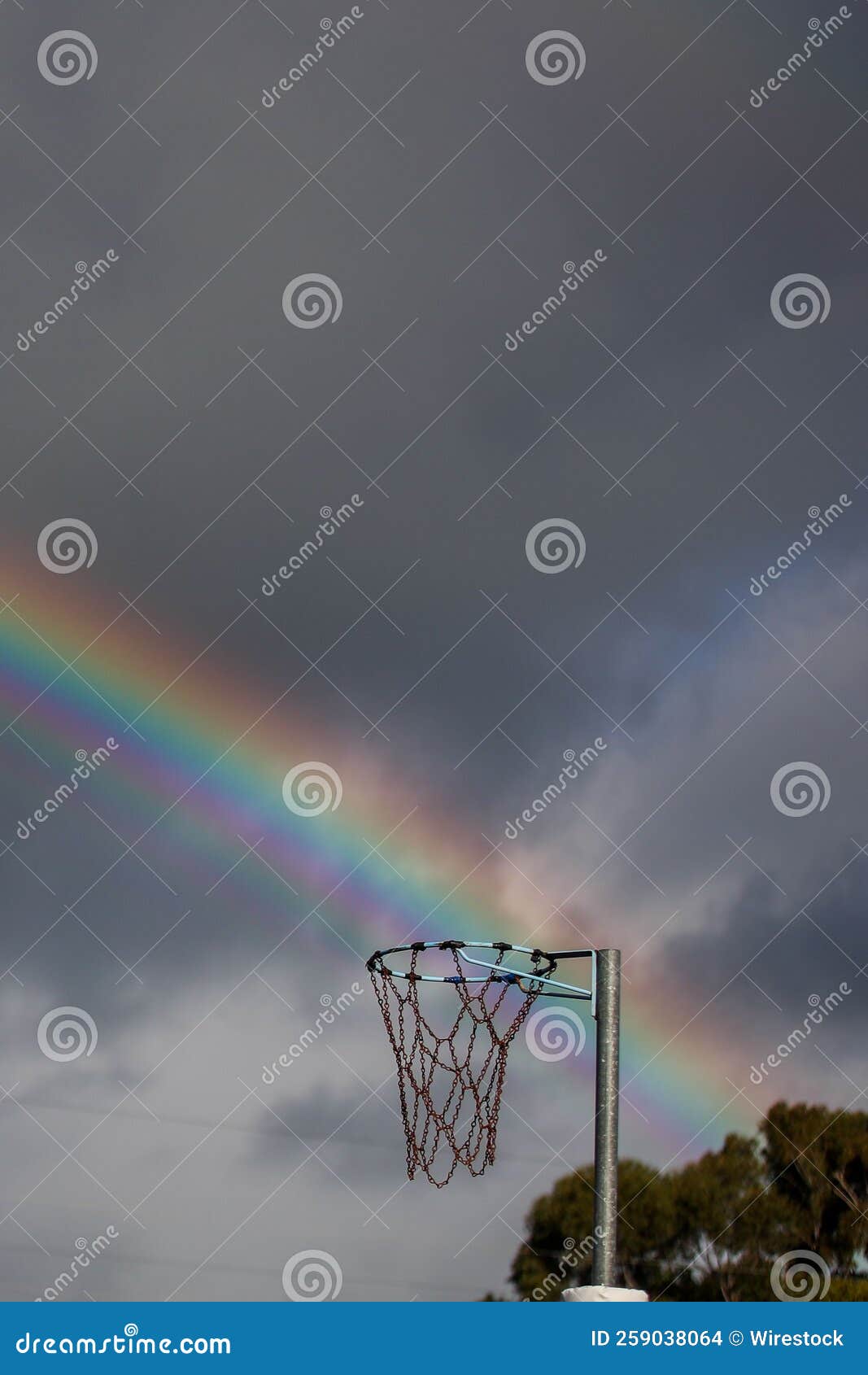Vertical Shot of a Netball Ring Against Rainbow in the Sky Stock Photo ...