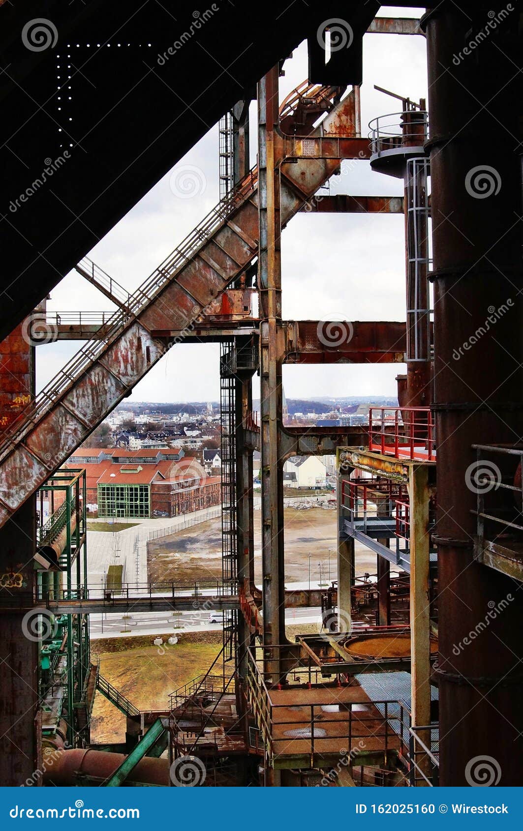 Vertical Shot of an Old Abandoned Rusty Factory with a Cloudy Sky in ...