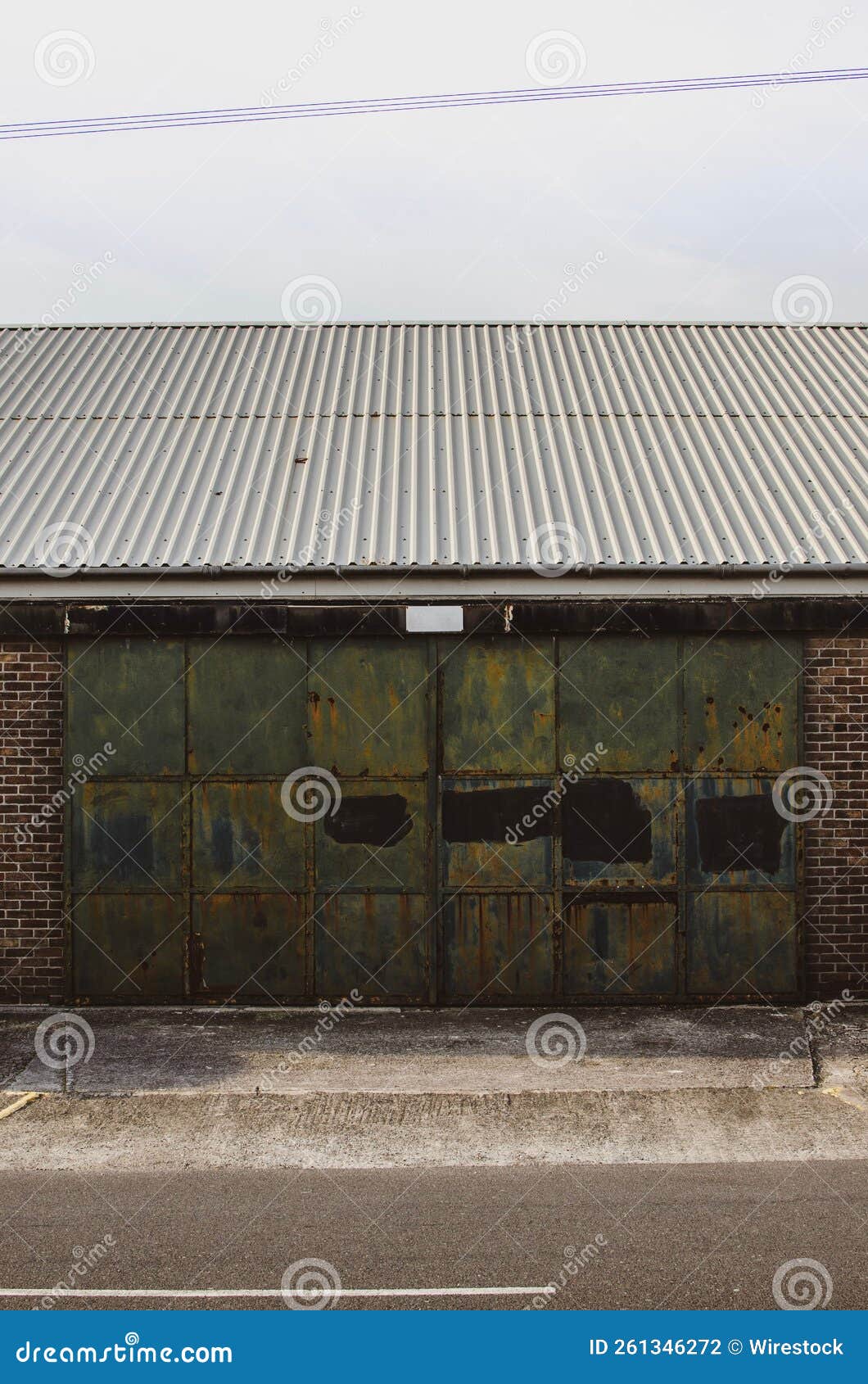 Vertical Shot of an Old Building with Rusty Doors Stock Photo - Image ...