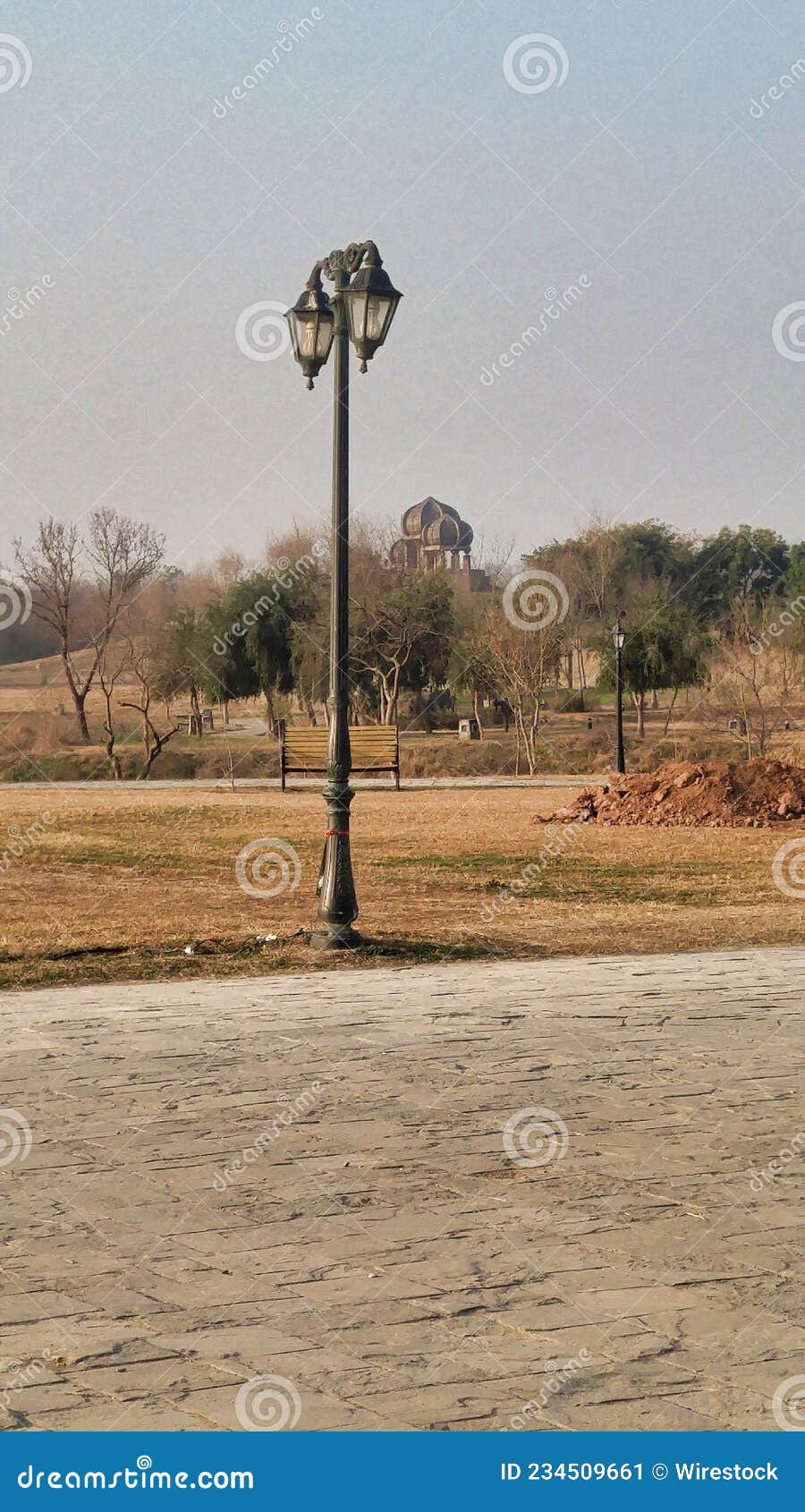 Vertical Shot of an Old Light Post on the Side Walking Path Pavement in ...