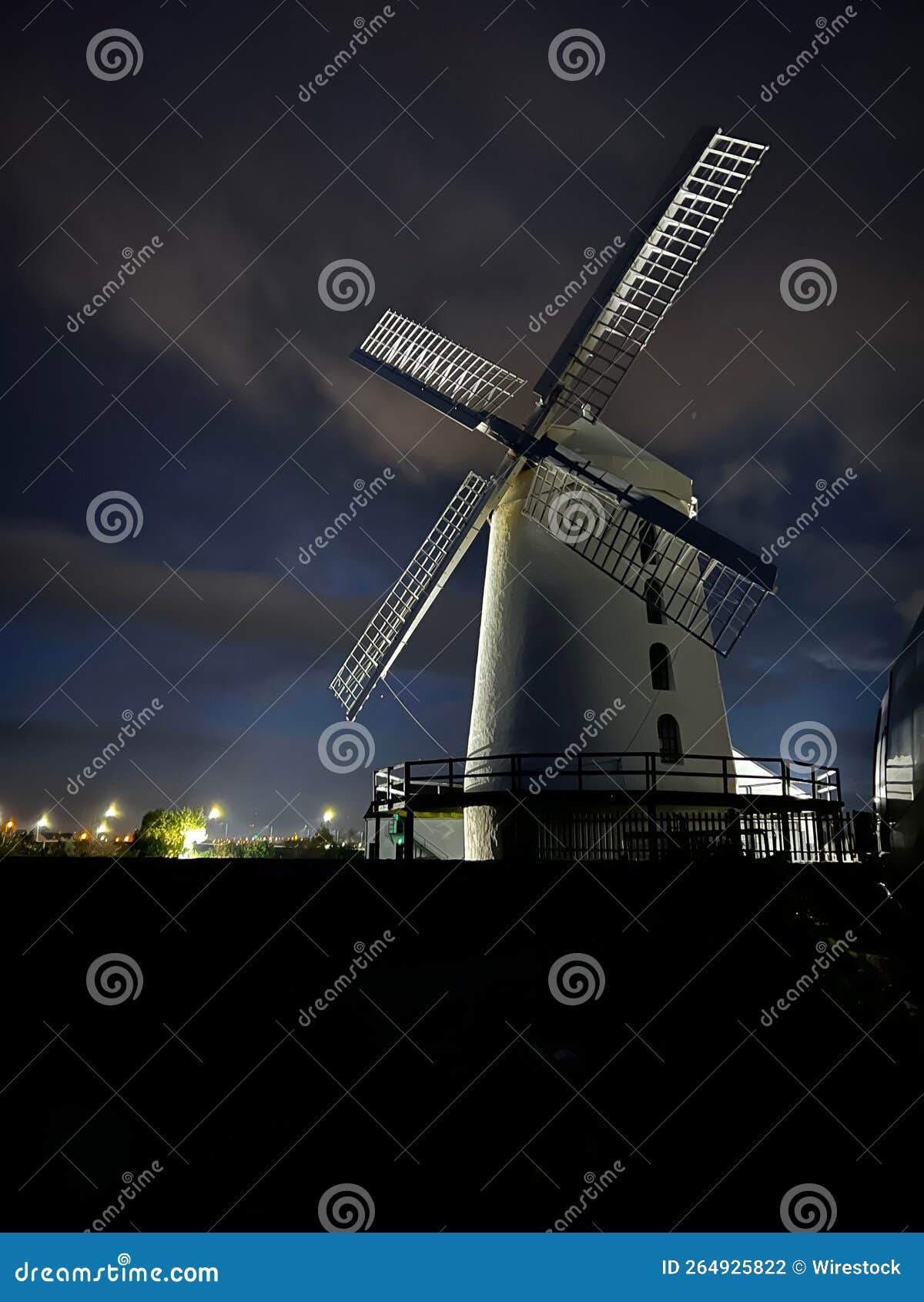 Vertical Shot of an Old Windmill Against a Cloudy Night Sky Stock Photo ...
