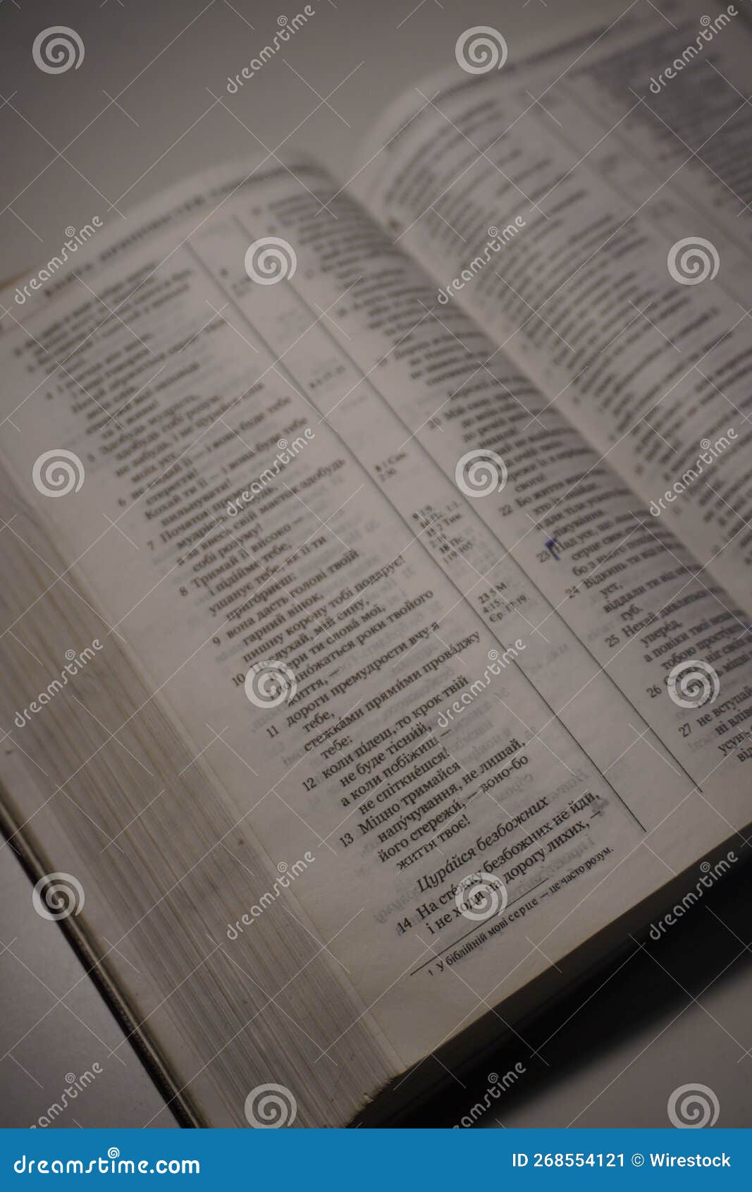 Vertical Shot of the Open Bible on the White Table Stock Image - Image ...