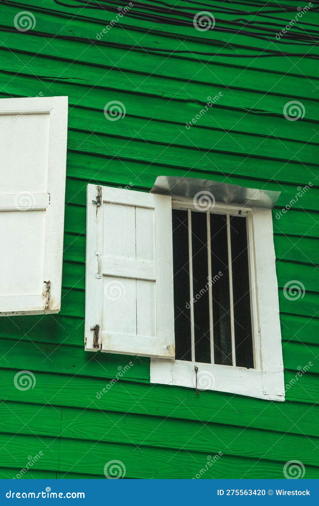 Vertical Shot of Open White Windows on a Green Wall Stock Photo - Image ...