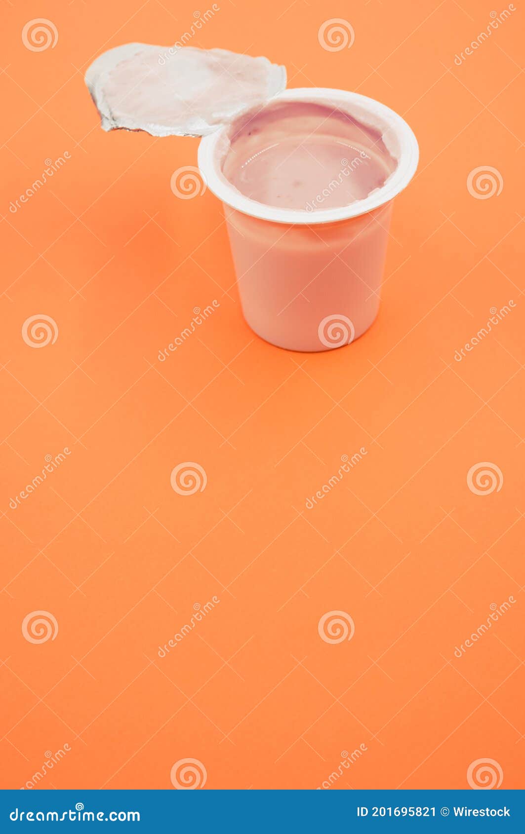 Vertical Shot of an Opened Fruit Yogurt on an Orange Surface Stock ...