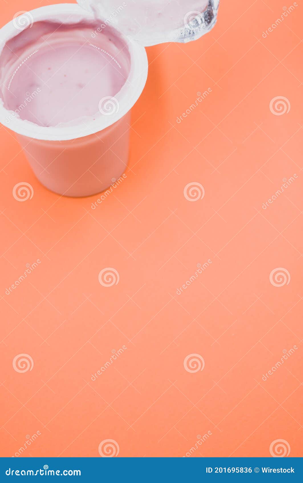 Vertical Shot of an Opened Fruit Yogurt on an Orange Surface Stock ...
