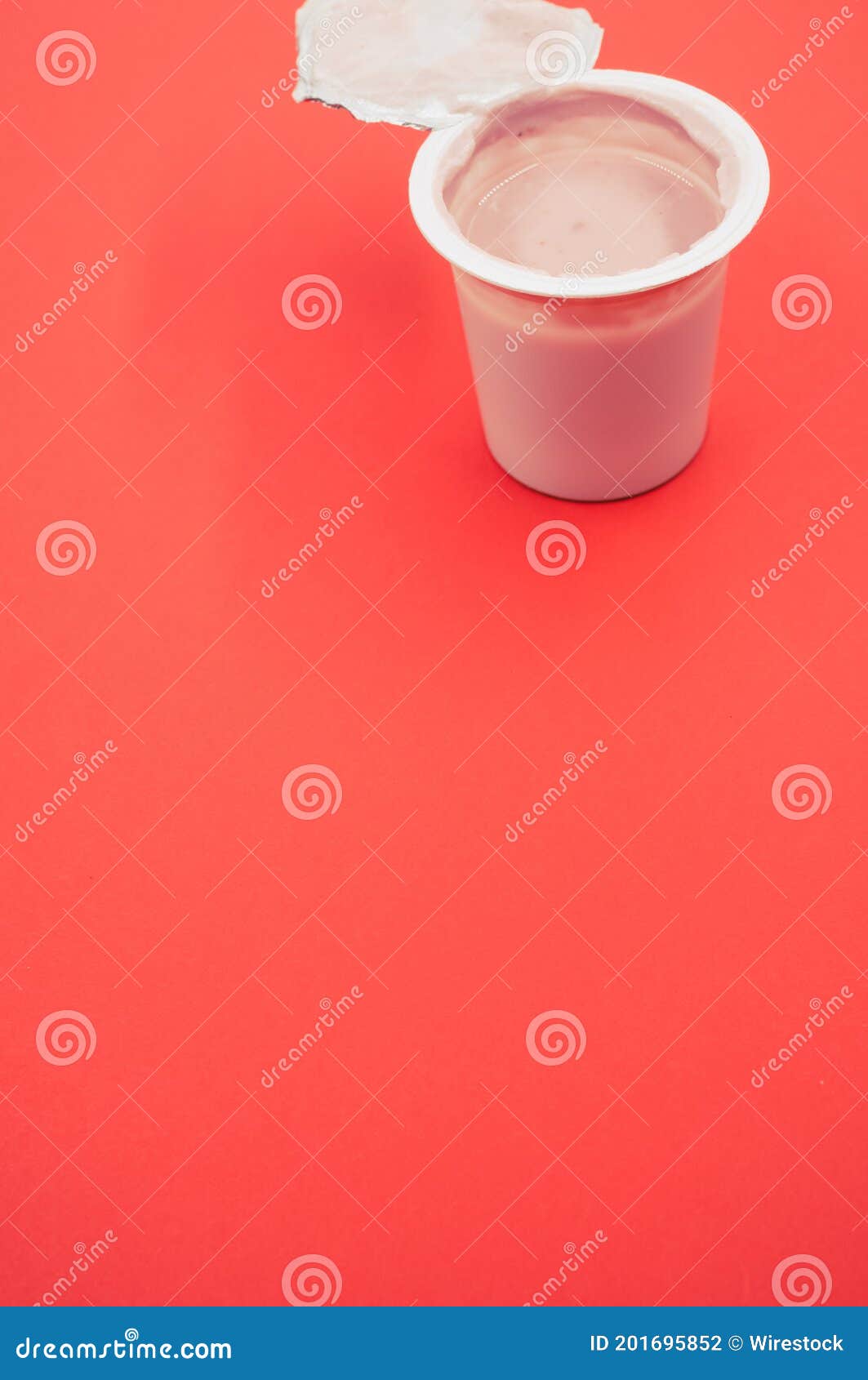 Vertical Shot of an Opened Plastic Container of Fruit Yogurt, on a Red ...