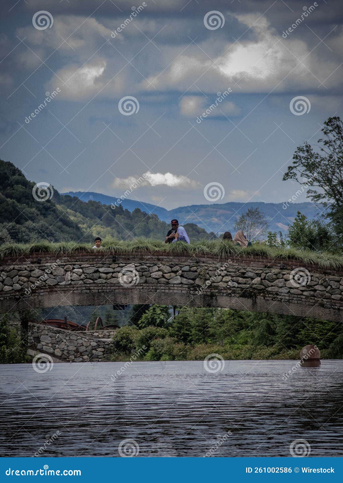 Vertical Shot of People on a Bridge Over River Stock Photo - Image of ...