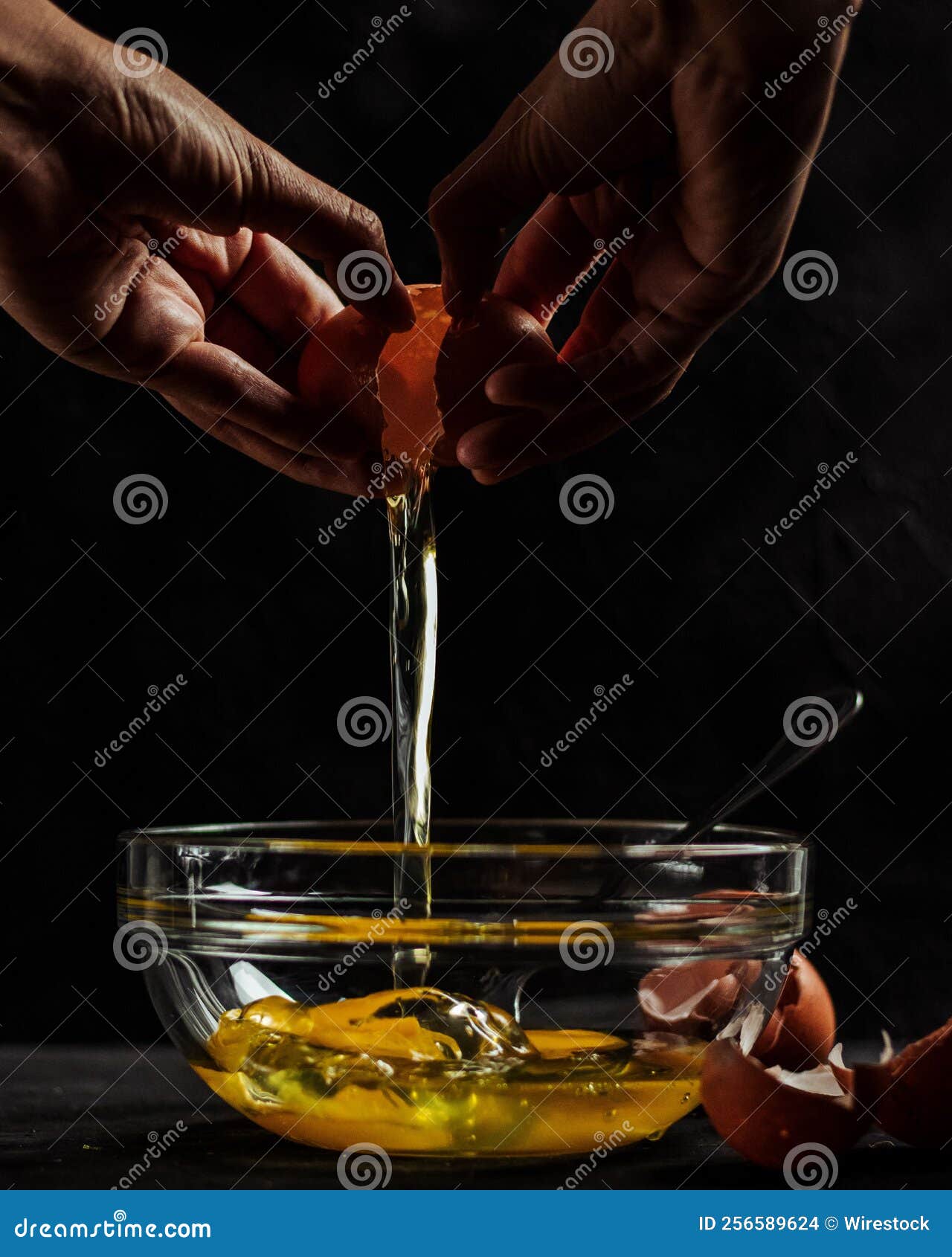 Vertical Shot of a Person Cracking an Egg into a Glass Bowl Stock Photo ...