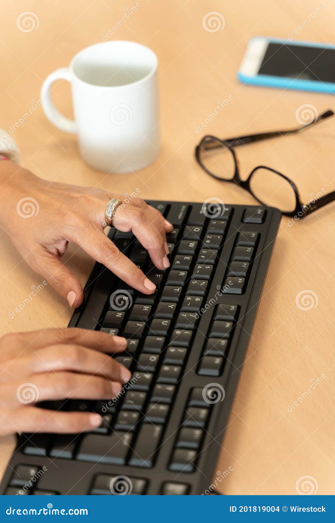 Vertical Shot of a Person Typing on a Keyboard of a Computer during the ...