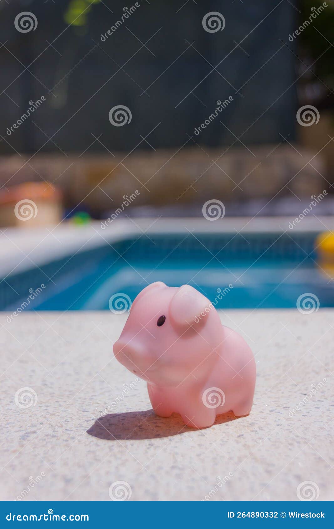 Vertical Shot of a Pink Piglet Toy on a Ledge Over a Pool Stock Photo ...