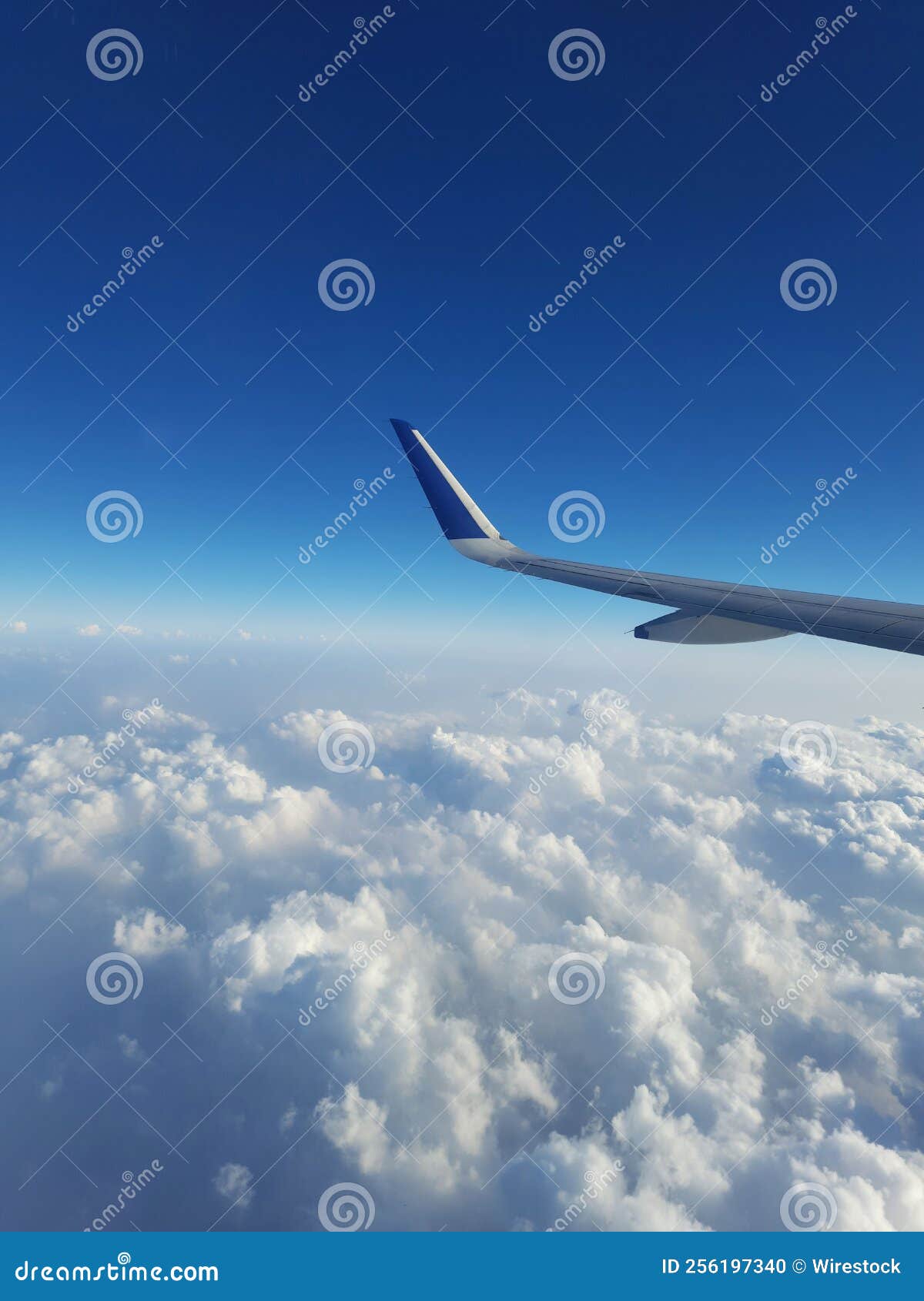 Vertical Shot of a Plane Wing Over the Clouds in Blue Sky Stock Photo ...