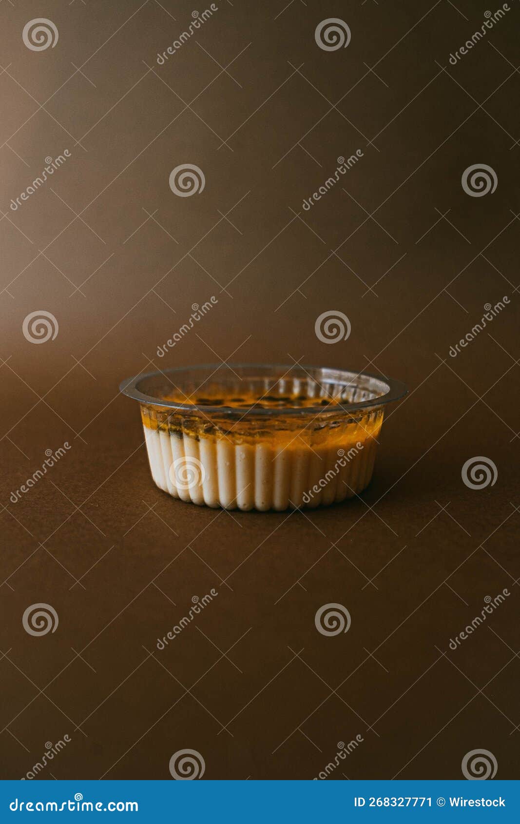 Vertical Shot of a Plastic Bowl of Creamy Pudding on a Brown Surface ...