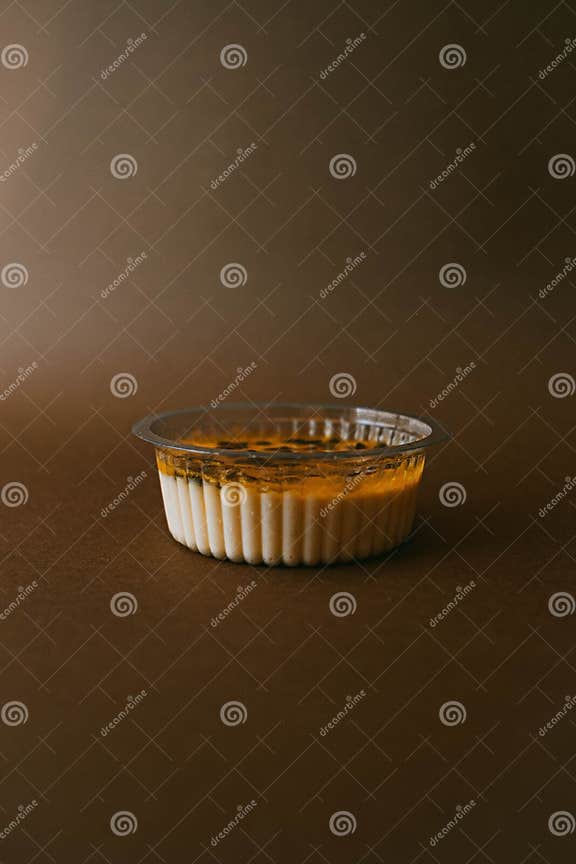 Vertical Shot of a Plastic Bowl of Creamy Pudding on a Brown Surface ...