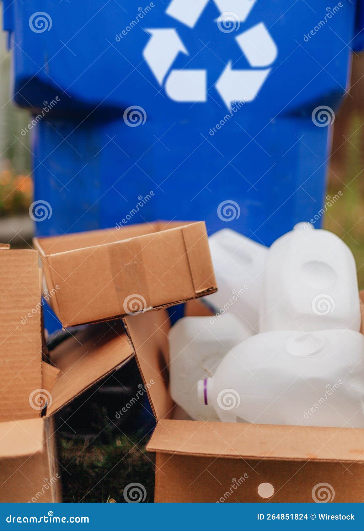 Vertical Shot of Plastic and Cardboard Boxes Placed Next To a Blue ...