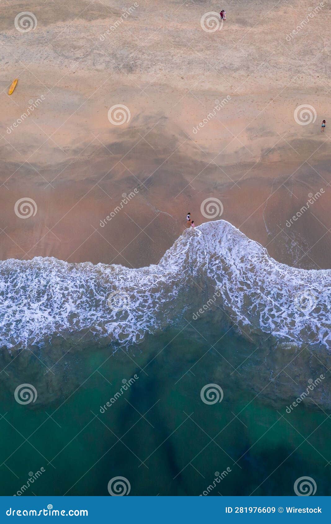 Vertical Shot of Powerful Ocean Waves Crashing Onto the Sandy Beach ...