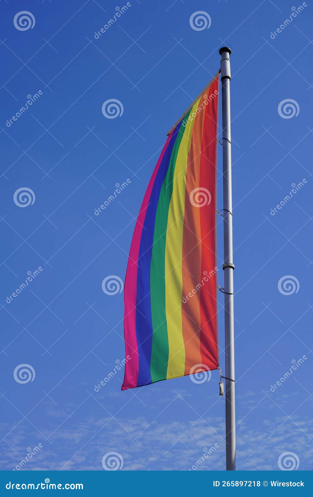 Vertical Shot of Pride Flag on a Pillar Against a Blue Sky Stock Photo ...
