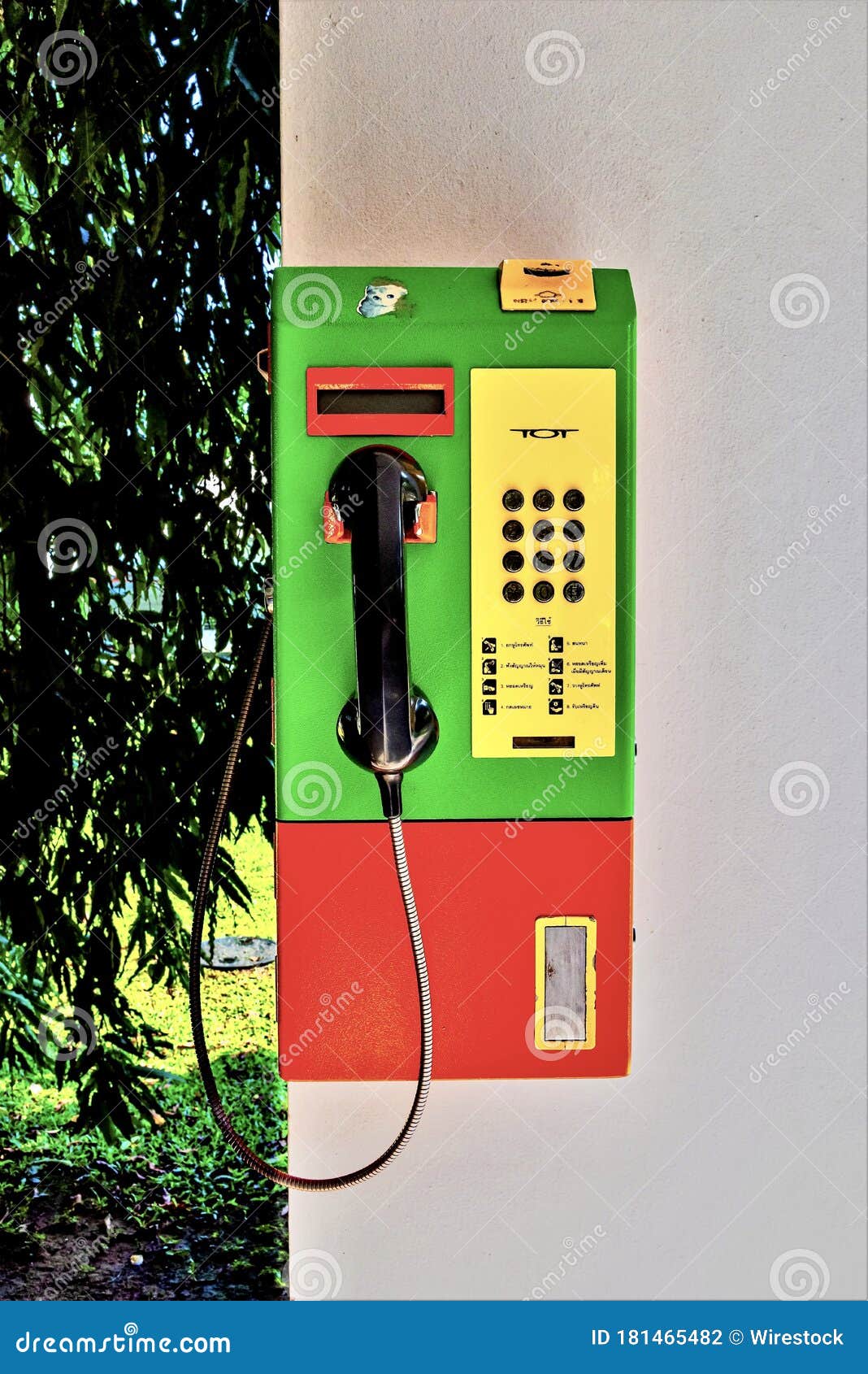 Vertical Shot of a Public Payphone on a White Wall Stock Photo - Image ...