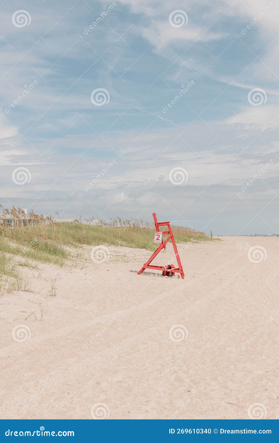 Vertical Shot of a Red Lifeguard Chair on the Sandy Beach Stock Photo ...