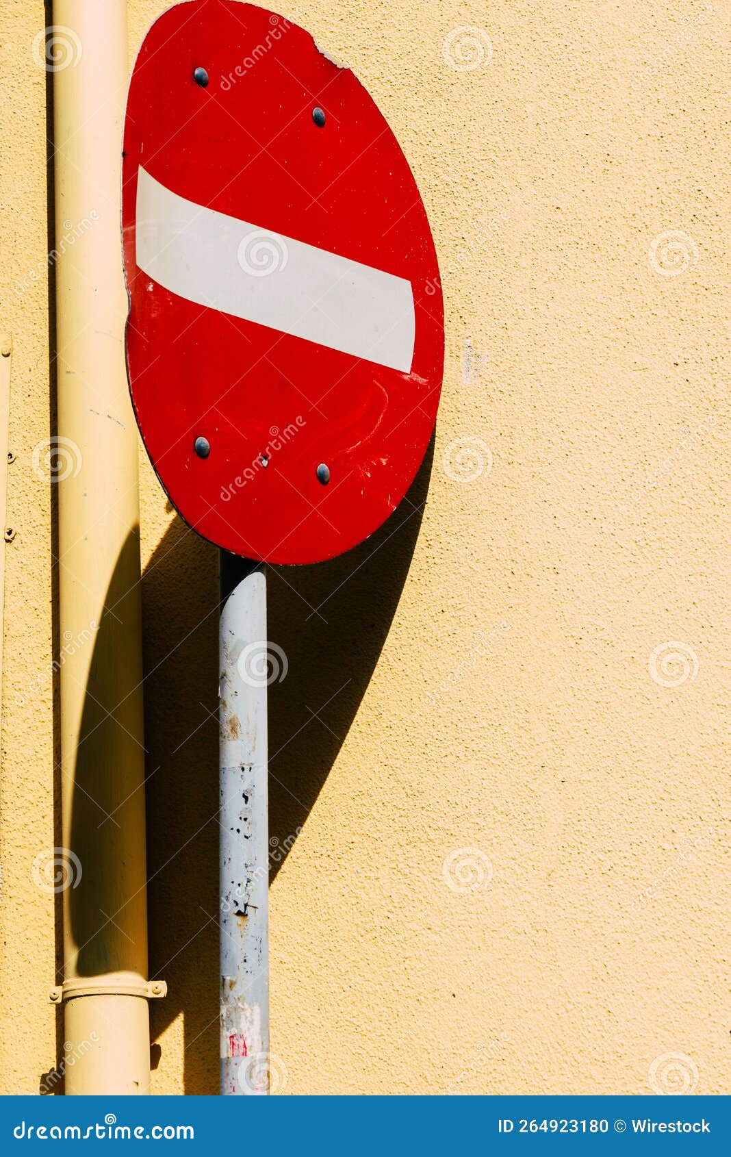 Vertical Shot of Red No Entry Sign Pole Leaning on Peach Building Stock ...