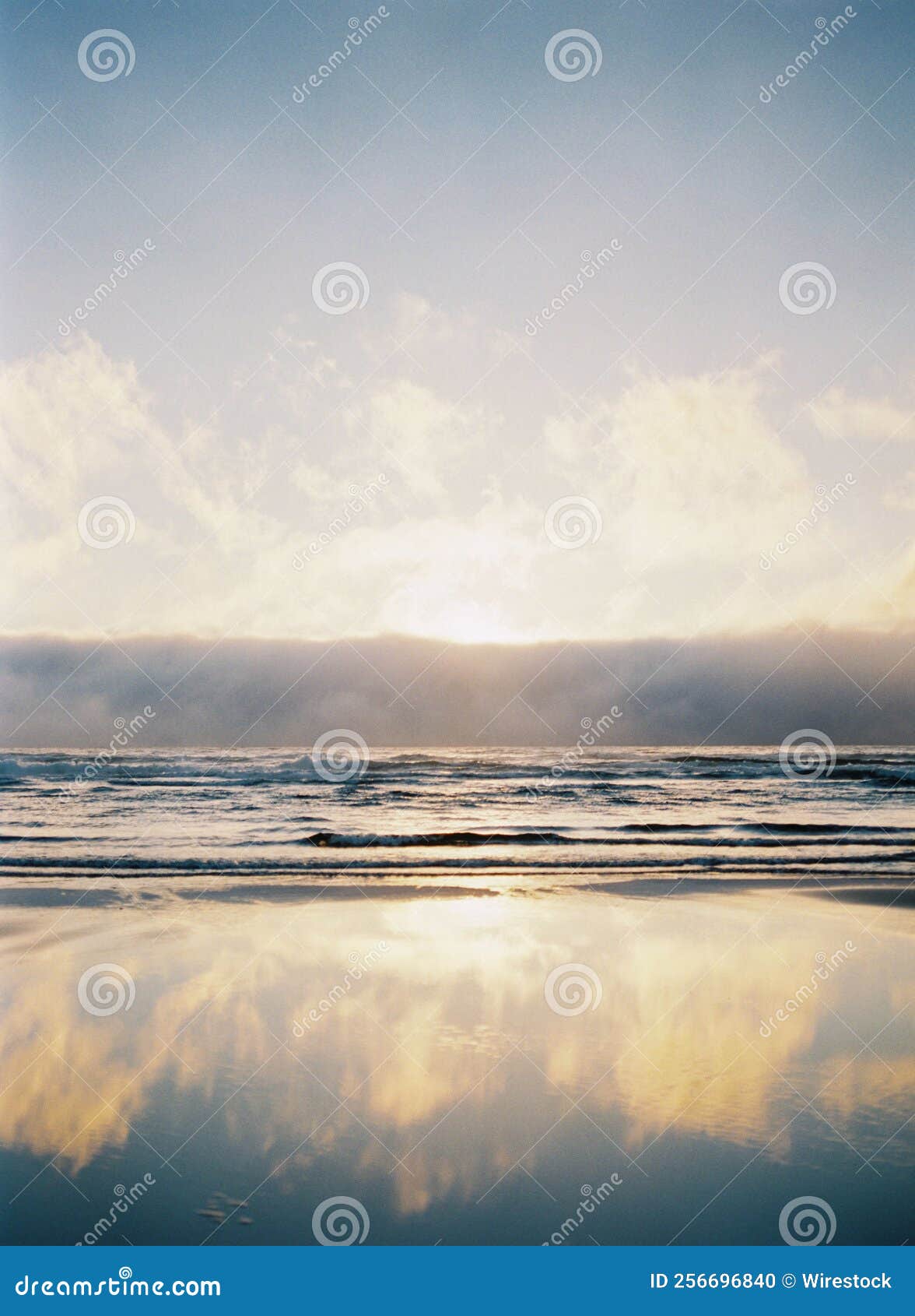Vertical Shot of the Reflection of Clouds in the Sunrise Ocean Under ...