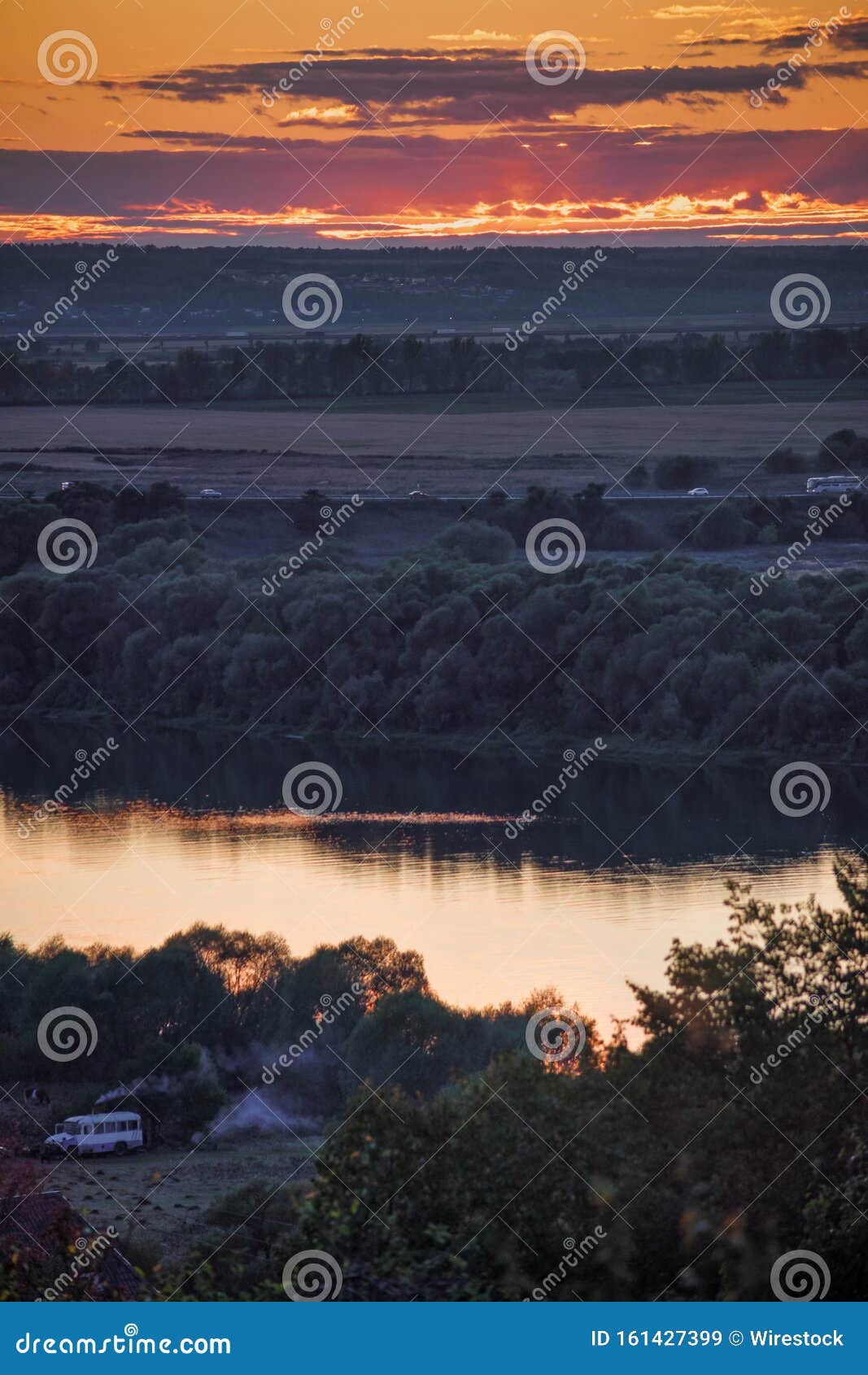 Vertical Shot of a River in the Middle of Trees with a Yellow Sky in ...