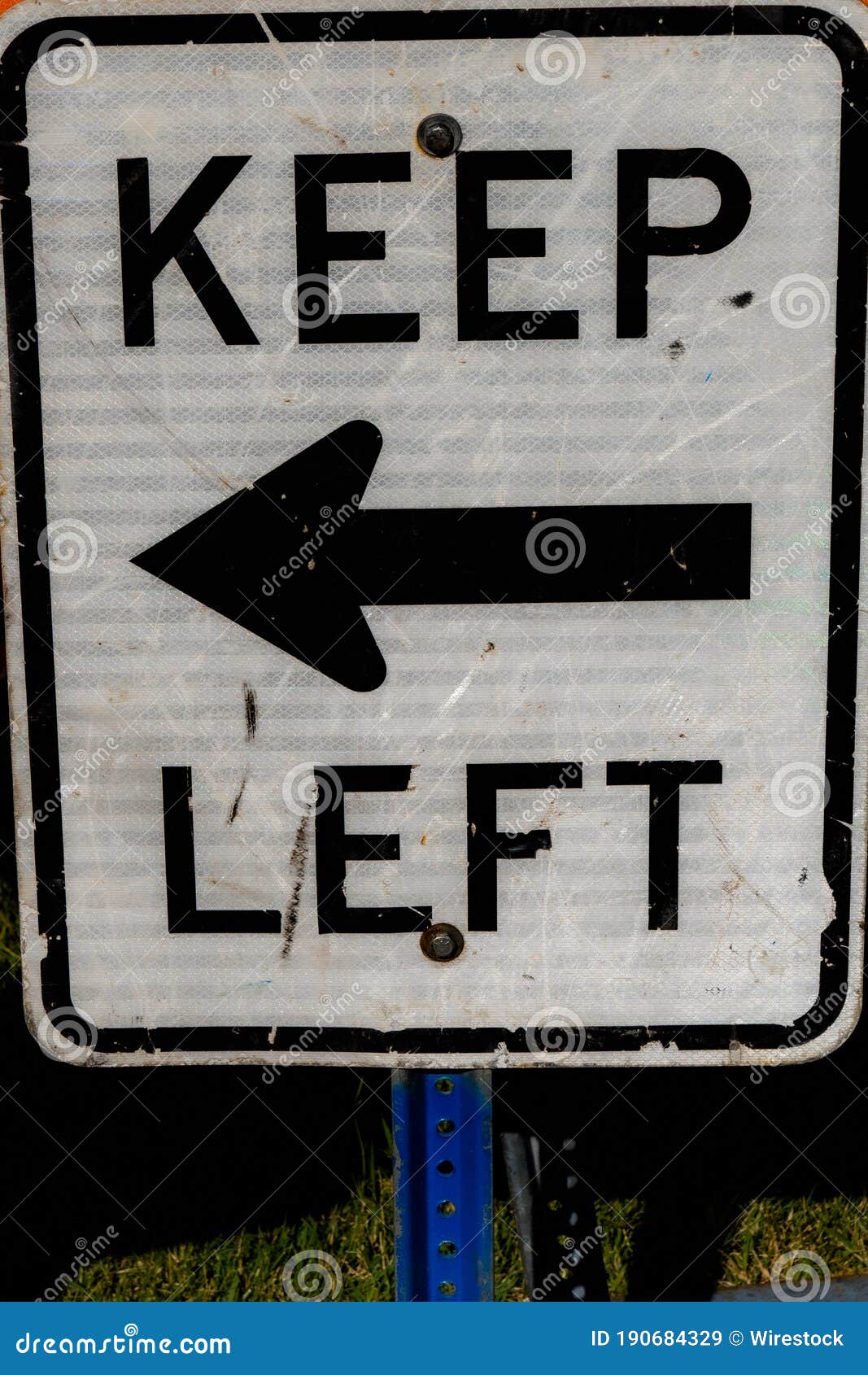 Vertical Shot of a Road Sign of "Keep Left " with an Arrow To the Left ...