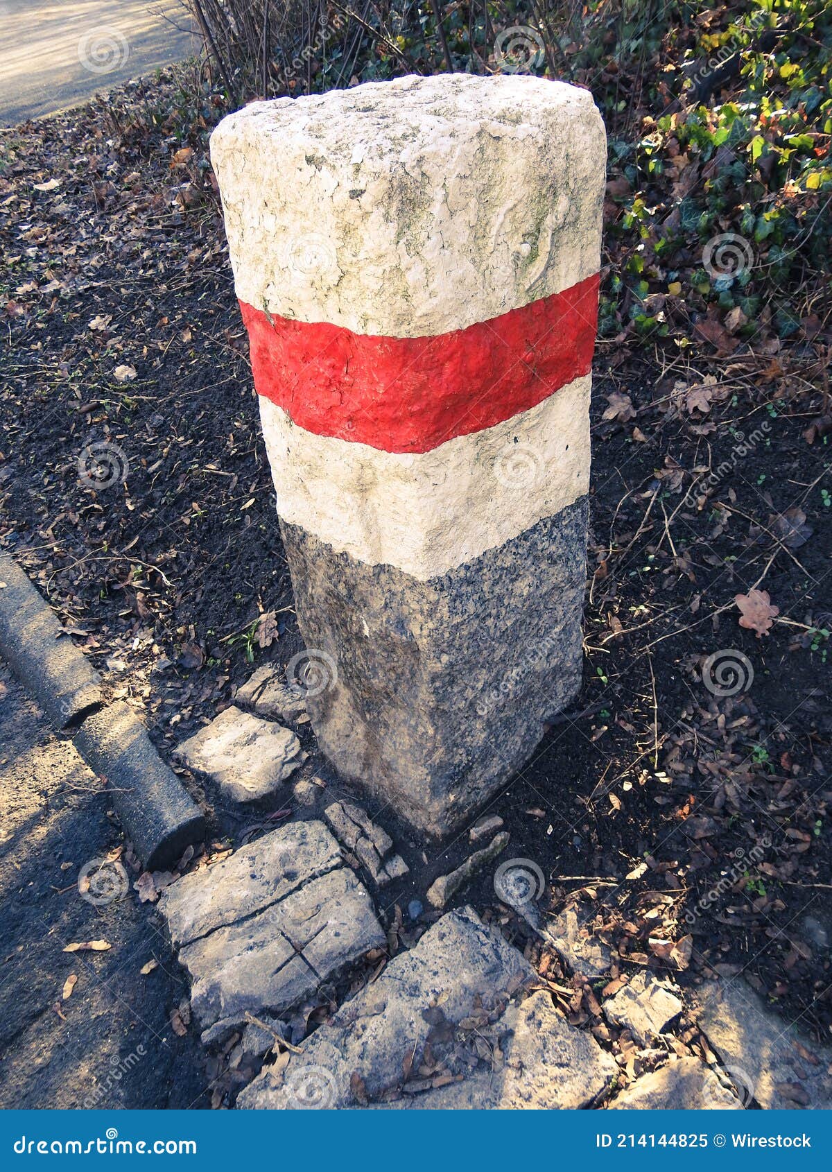 Vertical Shot of a Roadside Pillar Standing on a Muddy Ground Stock ...