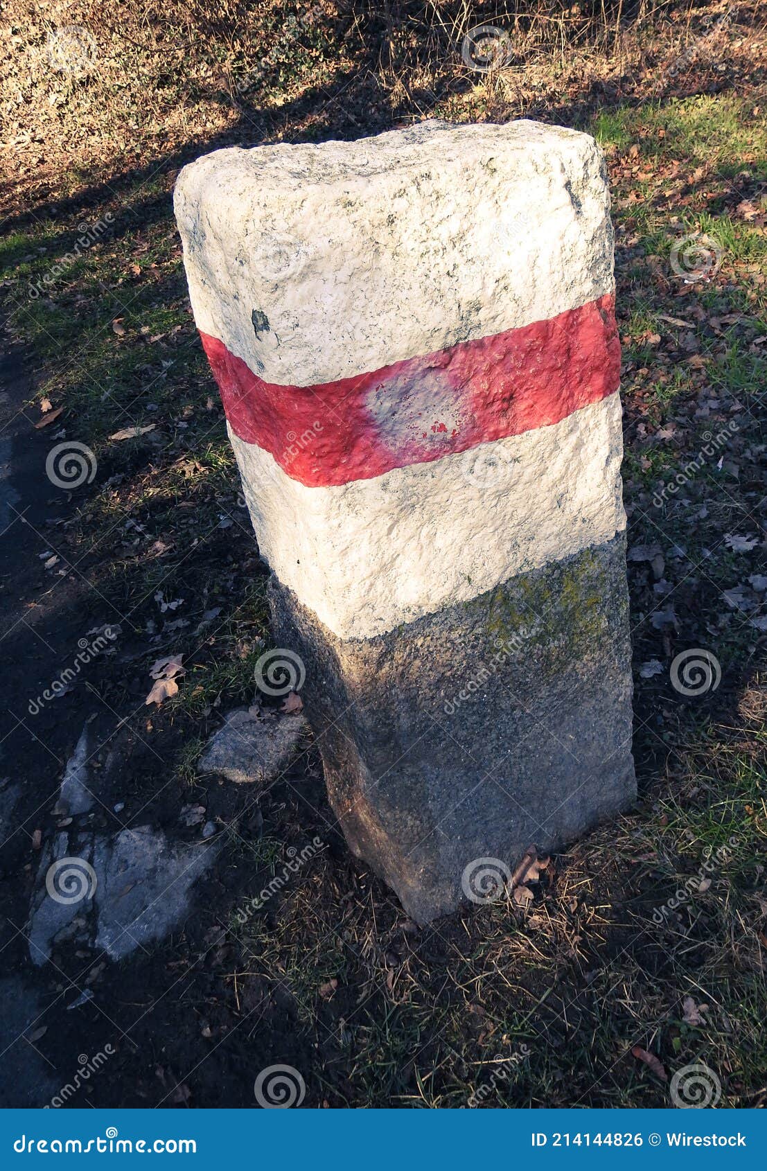 Vertical Shot of a Roadside Pillar Standing on a Muddy Ground Stock ...