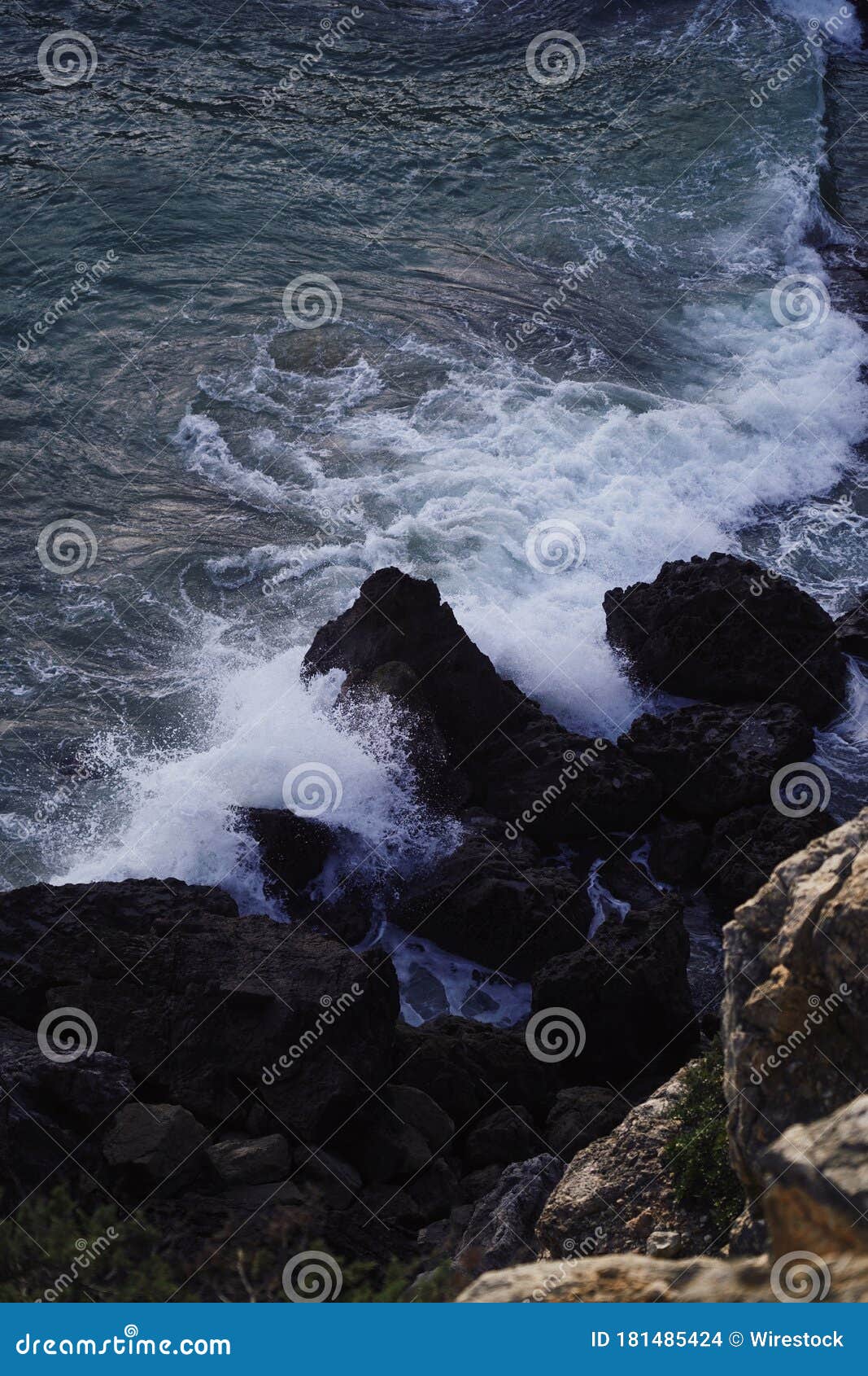 Vertical Shot of a Rogue Waves Crashing into Cliffs Stock Photo - Image ...
