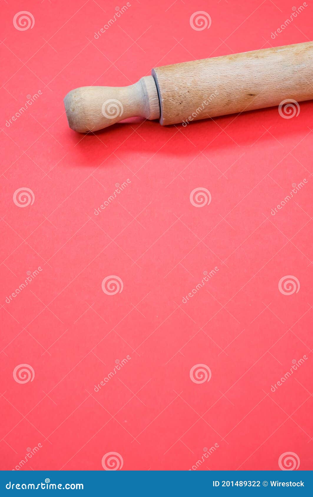Vertical Shot of a Rolling Pin on a Red Surface Stock Photo - Image of ...