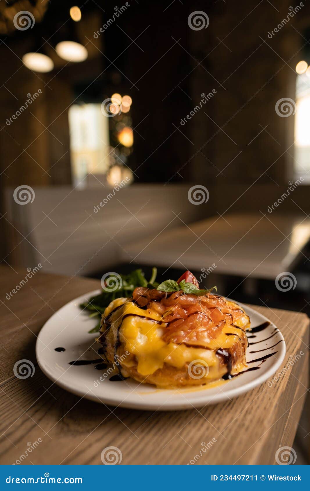 Vertical Shot of a Sandwich Along with Some Greens on a Plate in a ...