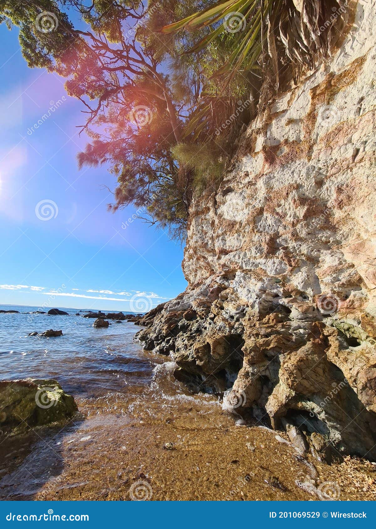 Vertical Shot of Sandy Coastline with Immense Cliffs Covered with ...