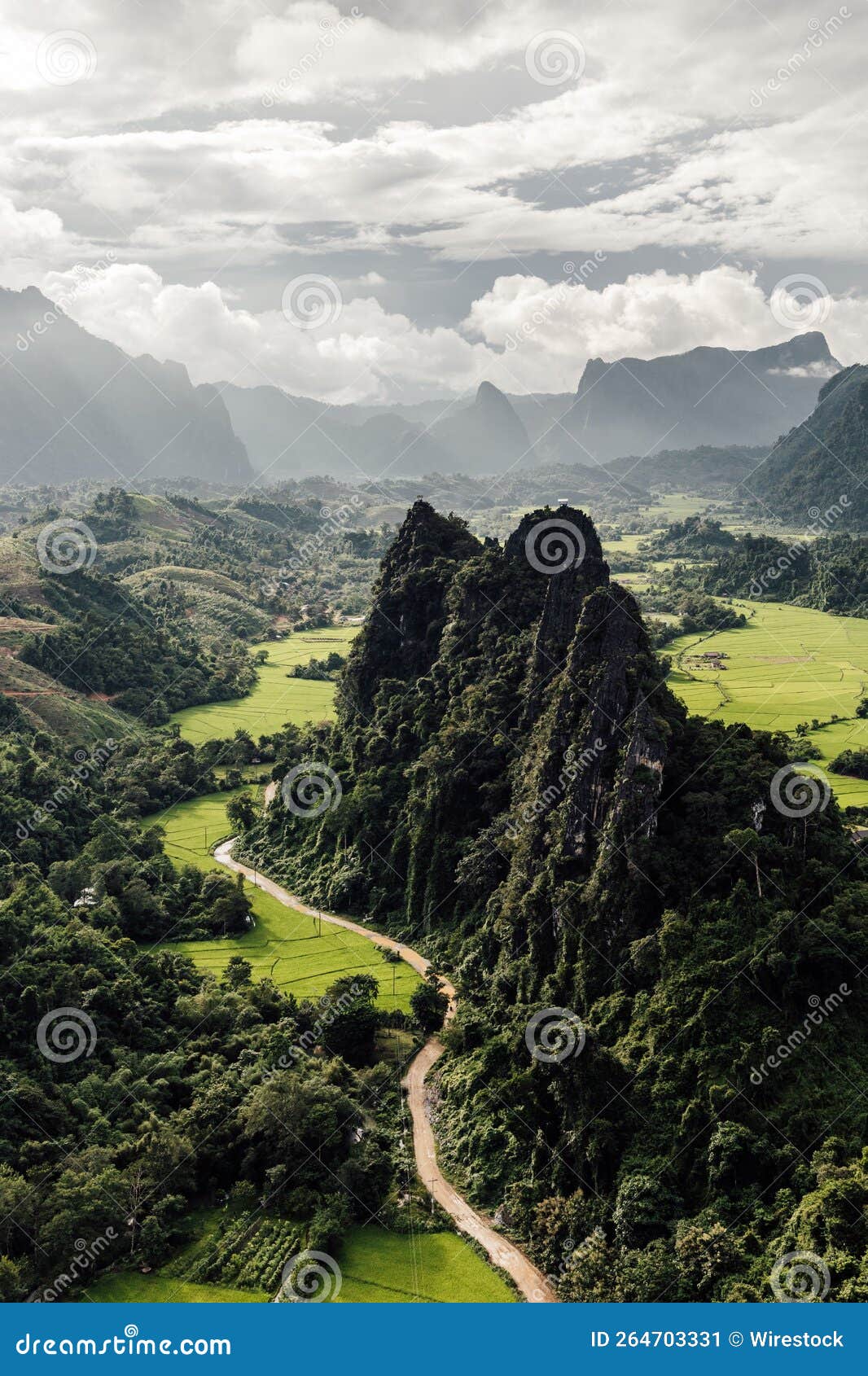 Vertical Shot of a Sharp Hill Covered with Trees and a Path beside it ...
