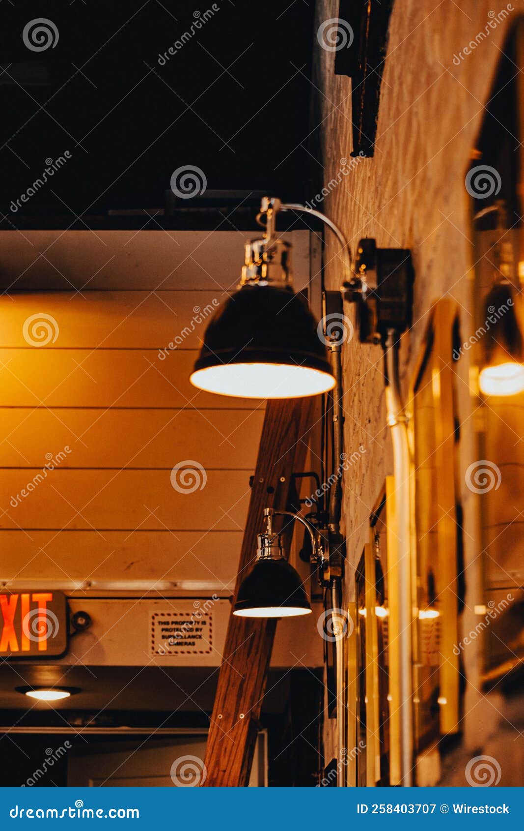 Vertical Shot of Shiny Photo Frames and Wall Lights Illuminating the ...