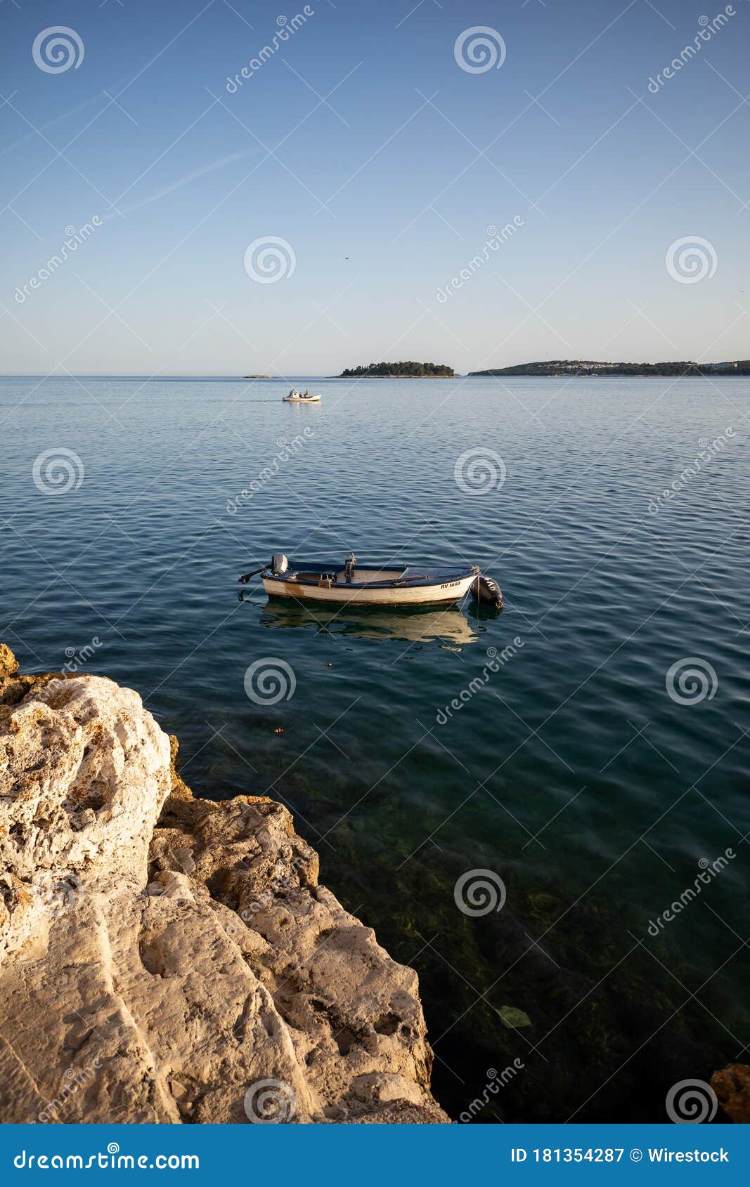 Vertical Shot of a Small Boat on a Blue Ocean Background Editorial ...