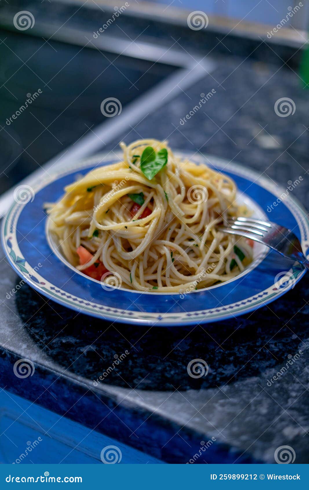 Vertical Shot of Spaghetti Pasta in a Blue Plate Stock Photo - Image of ...