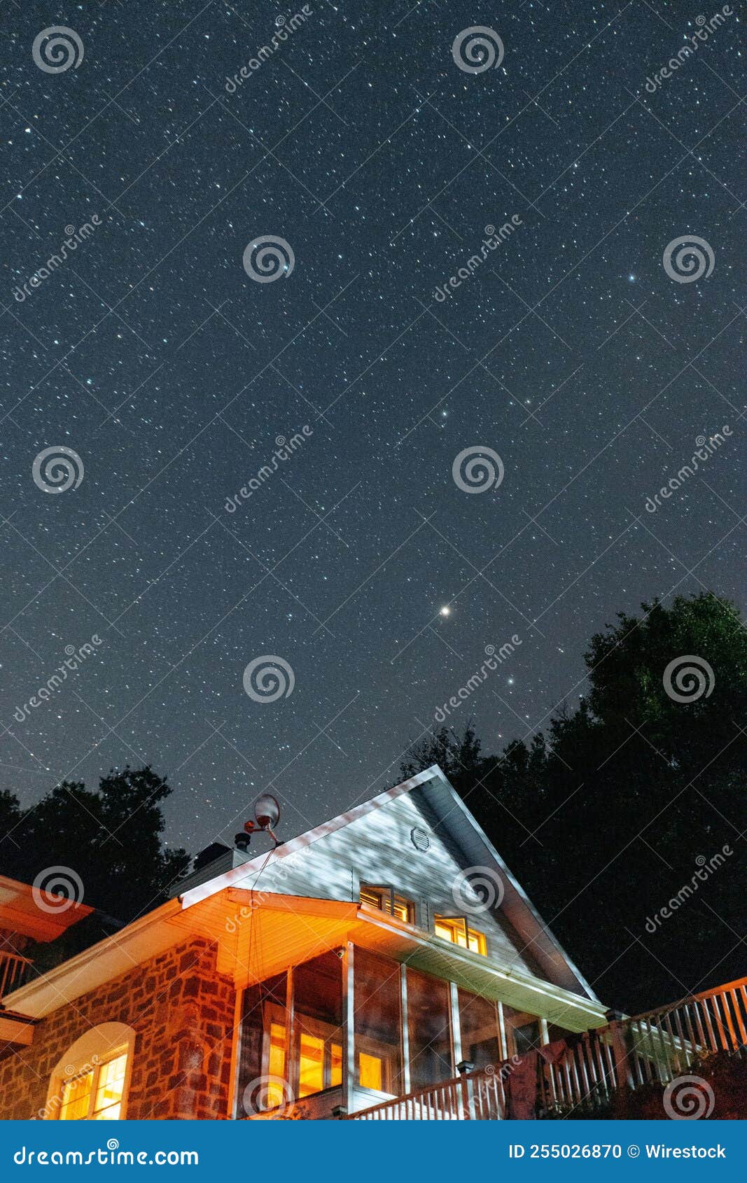 Vertical Shot of a Starry Night with a Large Cabin Under it Stock Photo ...