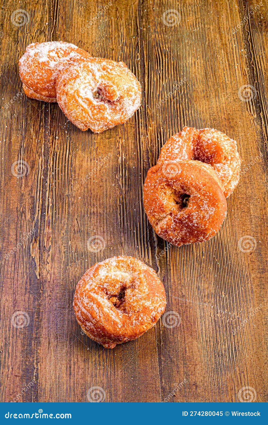 Vertical Shot of Sugary Donuts on a Wooden Surface Stock Image - Image ...