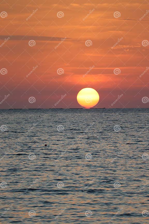 Vertical Shot of the Sun Going Down Over the Ocean Stock Photo - Image of evening, dusk: 263431896