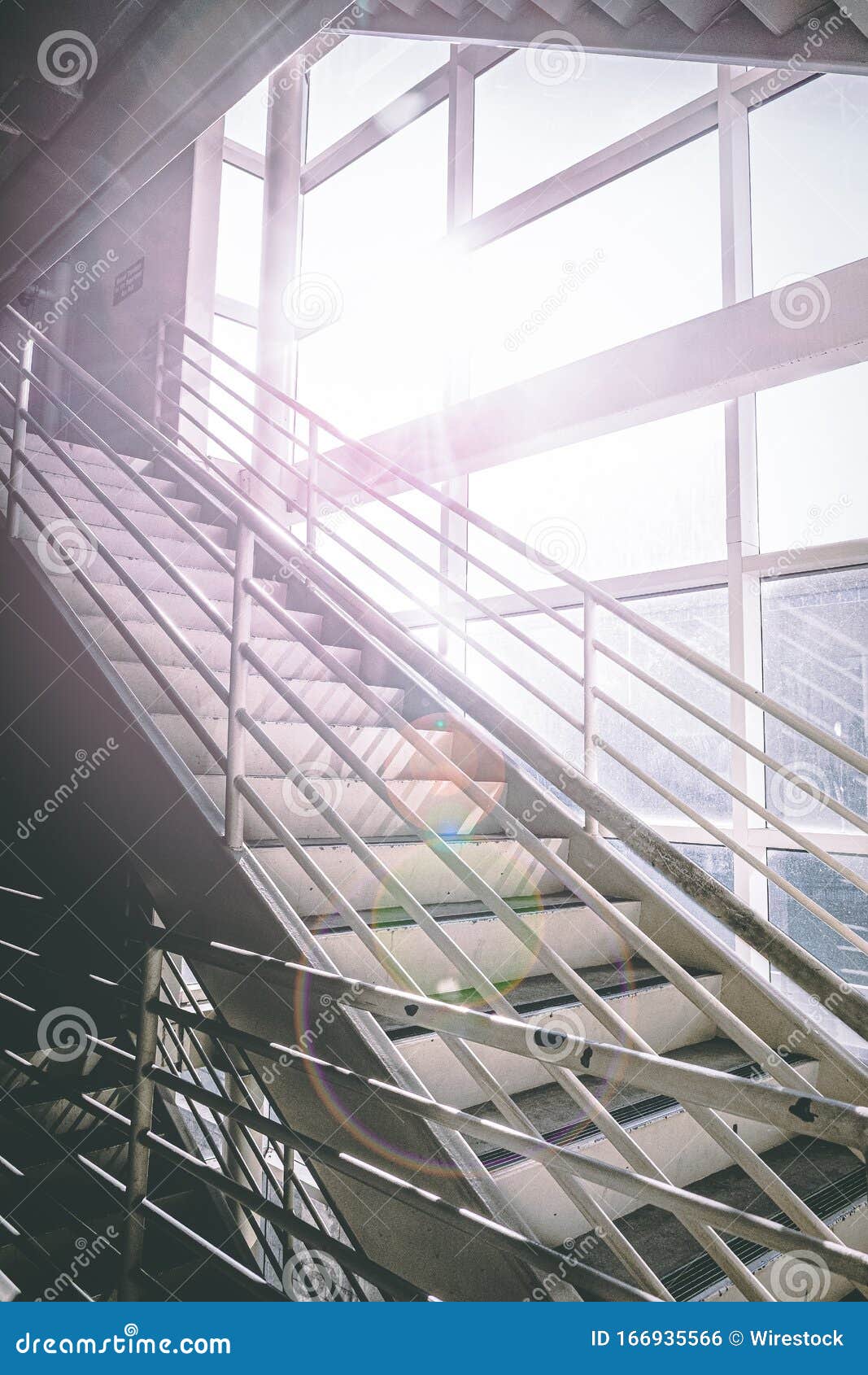 Vertical Shot of the Sun Sliding through a Building with a Modern ...