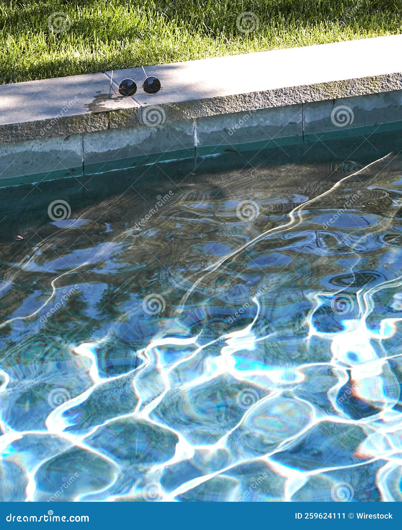 Vertical Shot of a Sunglasses on the Side of a Swimming Pool Stock ...