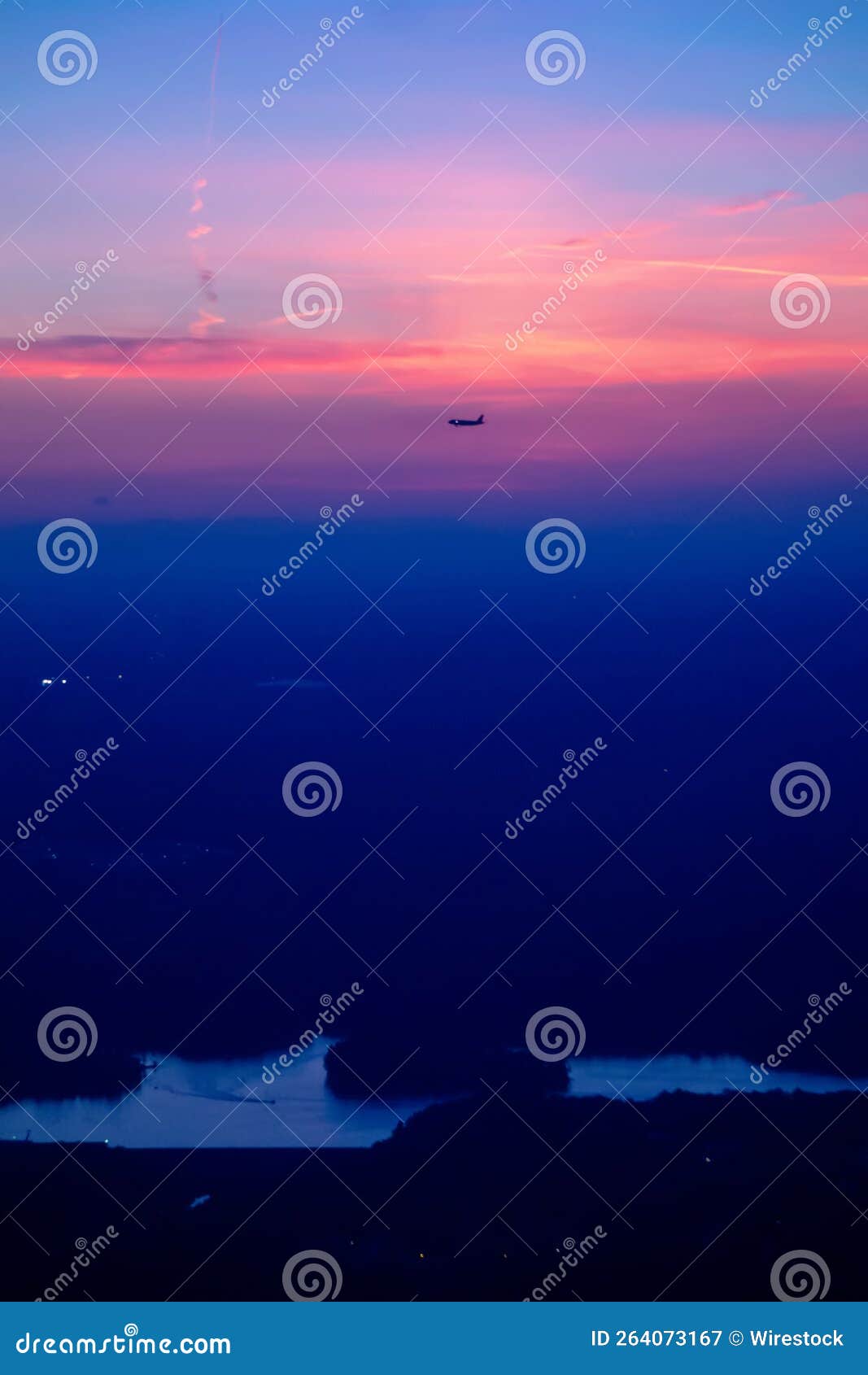 Vertical Shot of Sunset with an Airplane Flying in the Air Stock Image ...