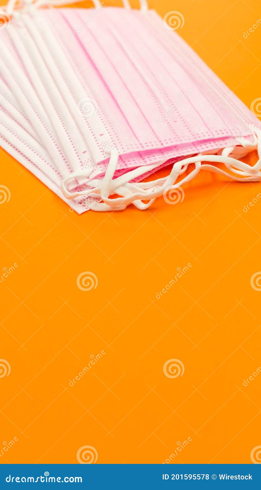 Vertical Shot of Surgical Masks on an Orange Surface Stock Photo ...