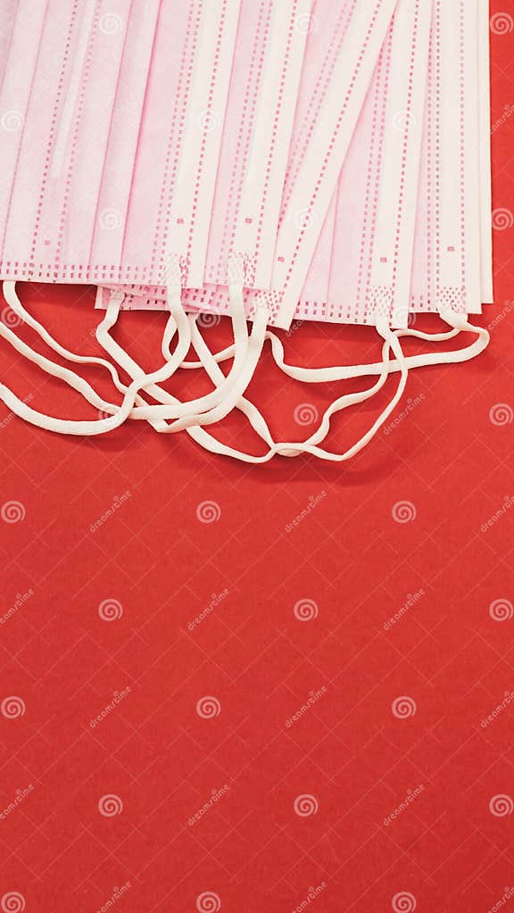 Vertical Shot of Surgical Masks on a Red Surface Stock Photo - Image of ...