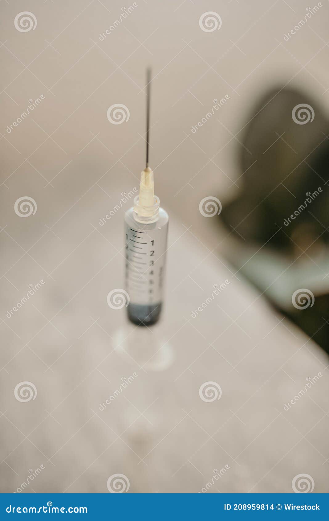 Vertical Shot of a Syringe Against a Light Background Stock Photo ...