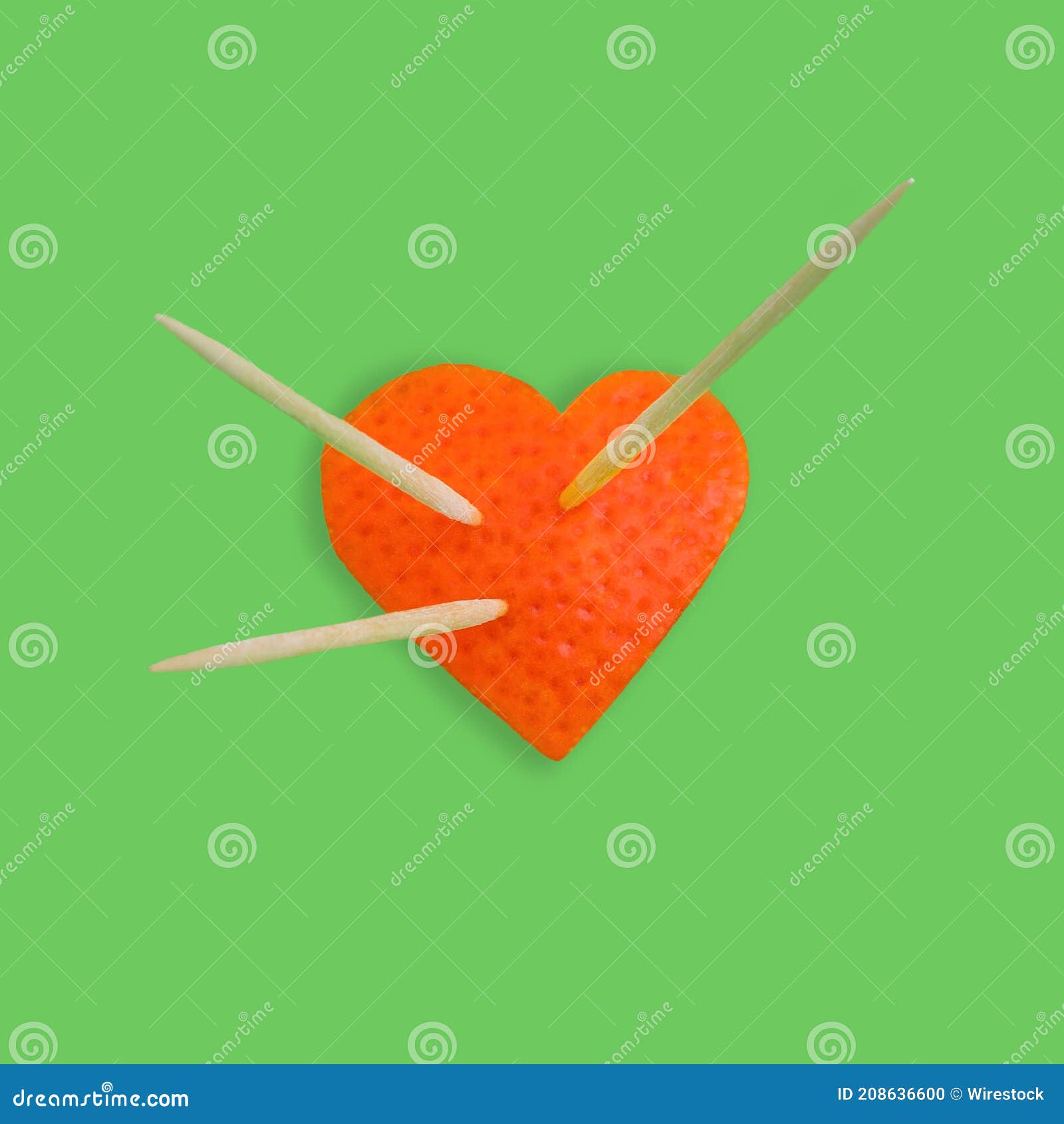 Vertical Shot of Toothpicks on an Orange Heart on a Green Background ...